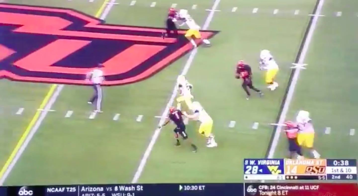 WATCH: Referee brings down West Virginia RB with devastating forearm ...