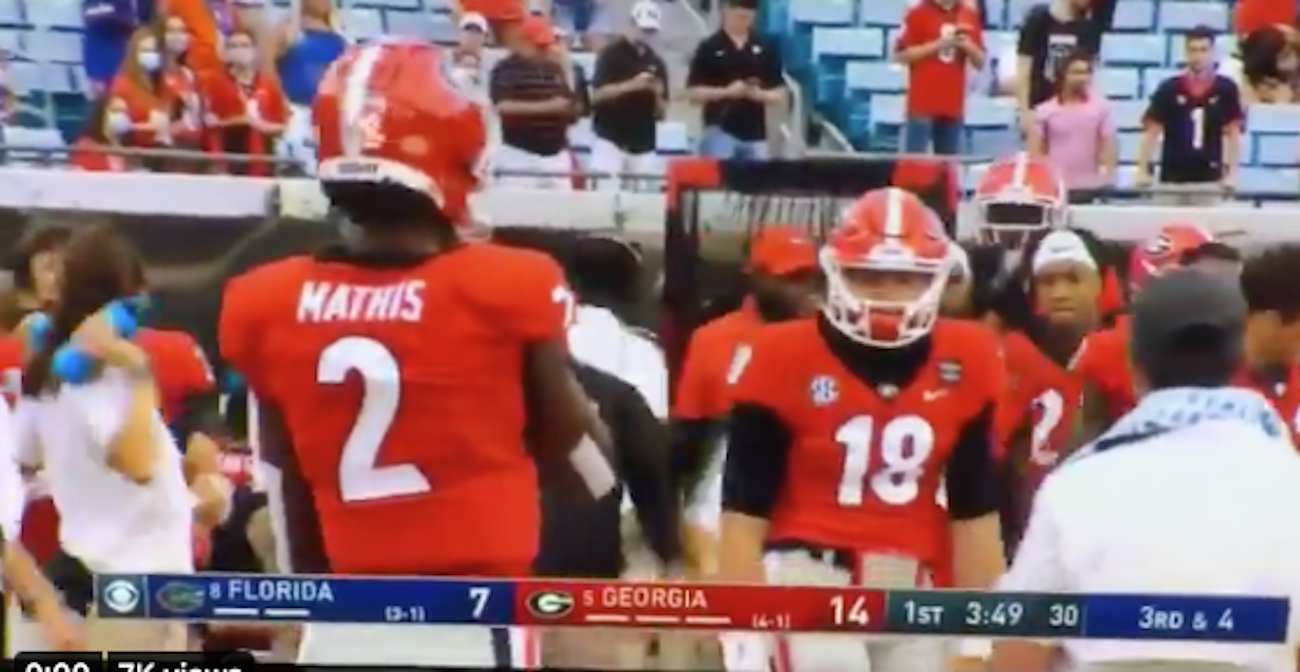 UGA QB D'Wan Mathis drills equipment manager on sideline while warming ...
